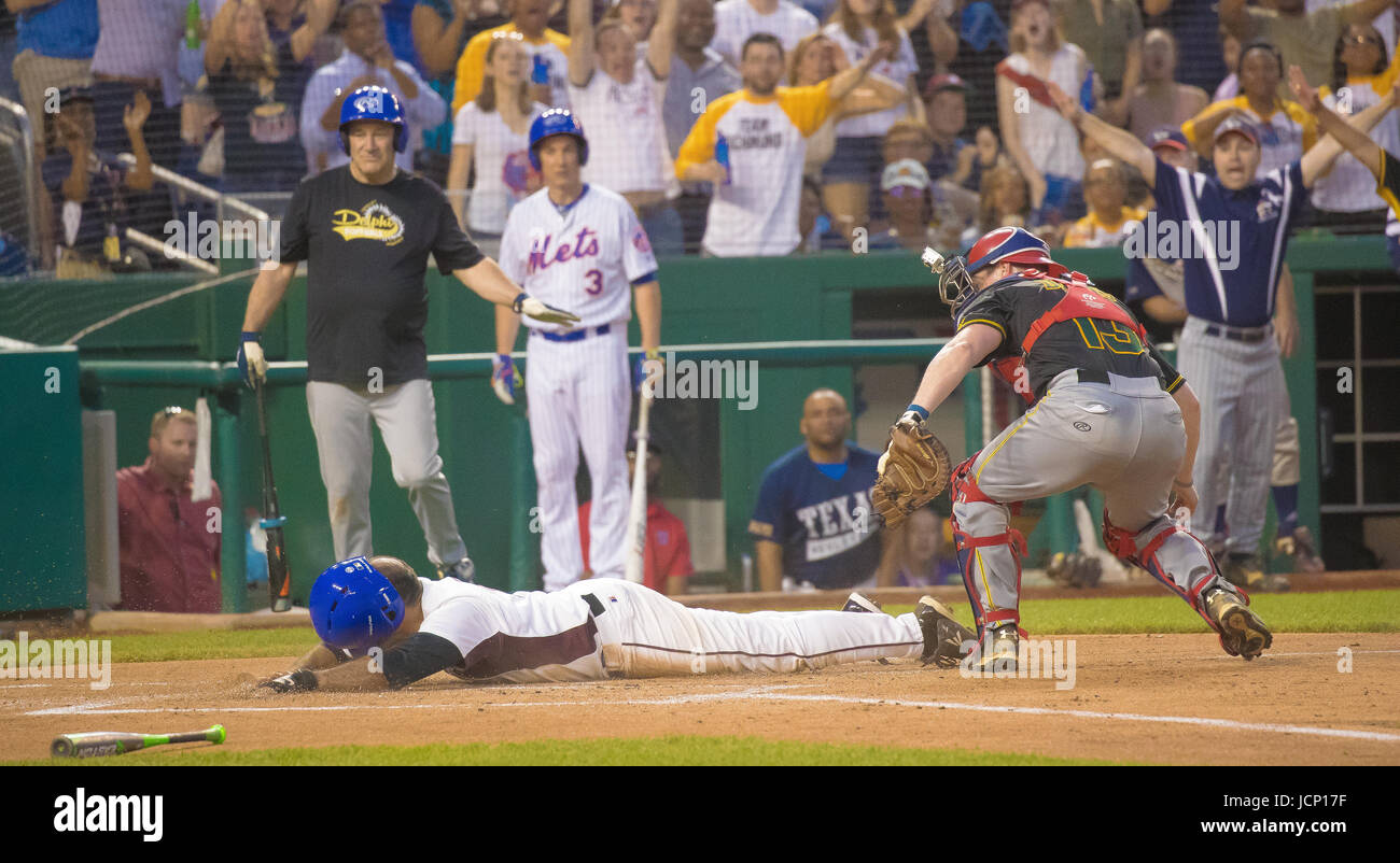 Rep. Jimmy Panetta (D-Calif.) heads for home plate with a head first ...
