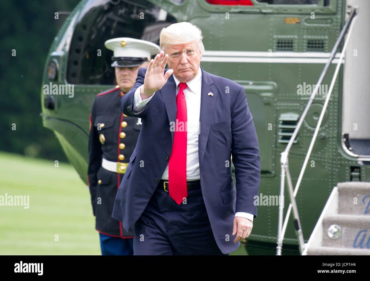 United States President Donald J. Trump waves to the press as he ...