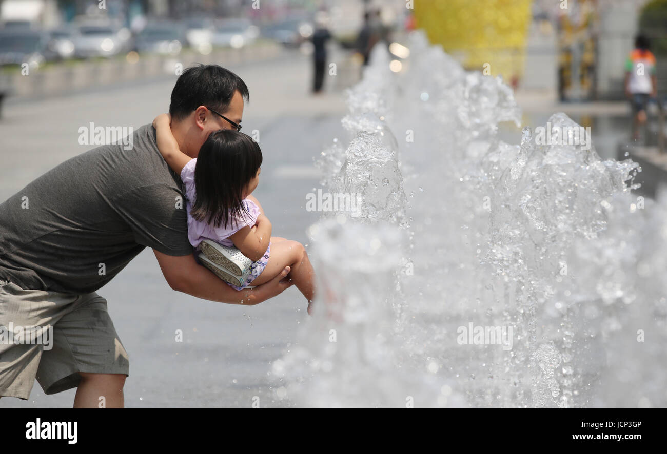 A day out in scorching heat A child is dabbling in water from a ...