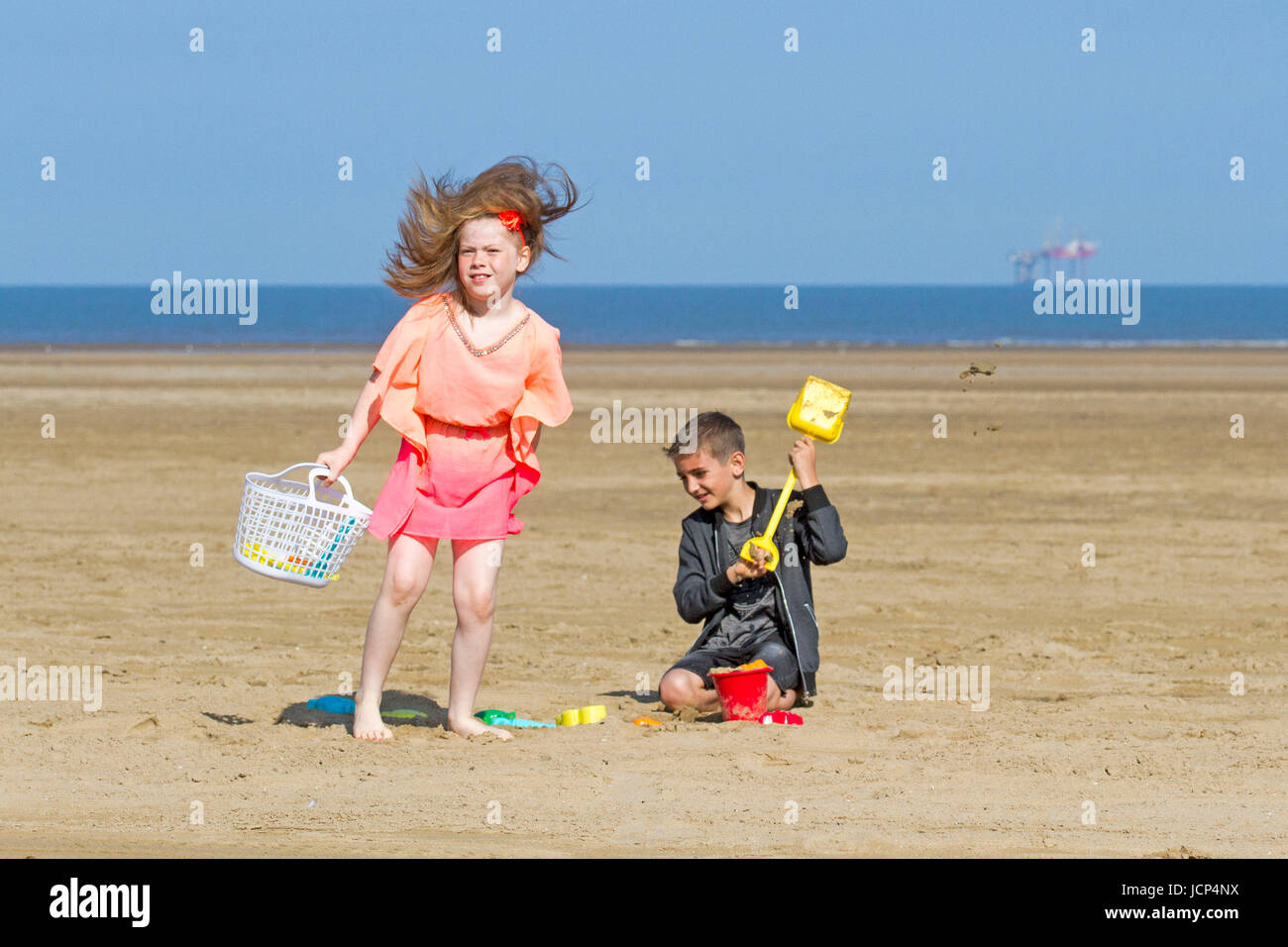 Southport, Merseyside, 17th June 2017. UK Weather. Half brother and ...