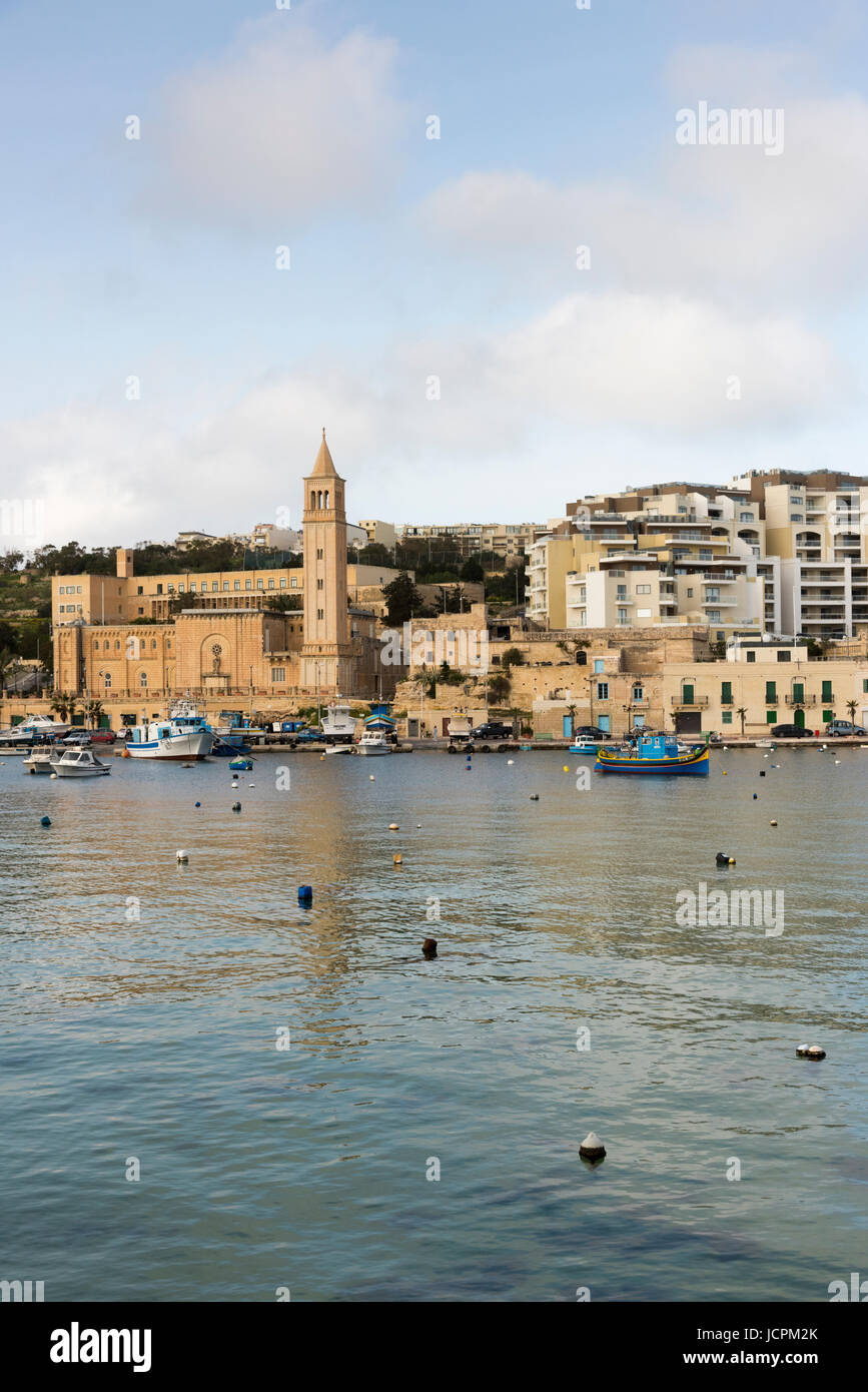 Buildings and holiday apartments and the parish church by the harbour ...