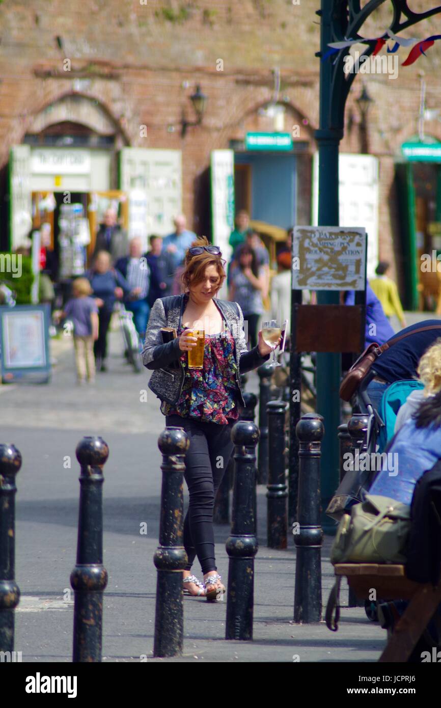 A Woman Carrying Drinks, Exeter Quay. Devon, UK. June, 2017 Stock Photo ...