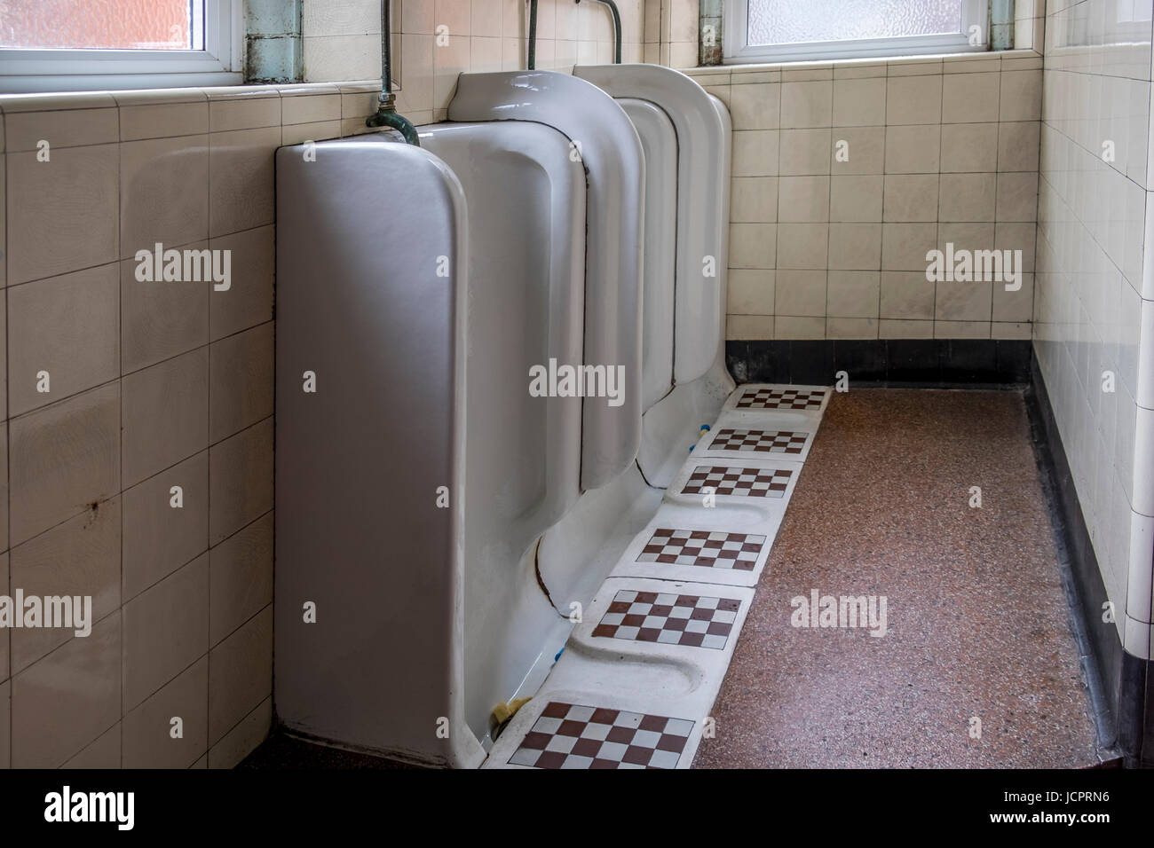 Men's urinal 3 in a row Stock Photo - Alamy