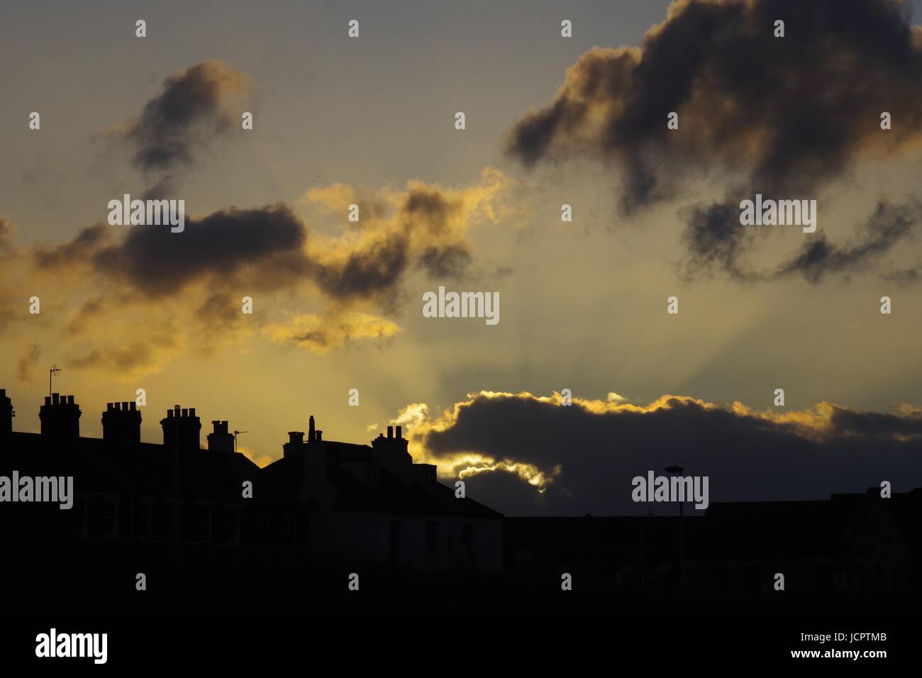 A Golden Sunset at Exeter Quay Silhouetting Rooftops and Chimney Pots ...