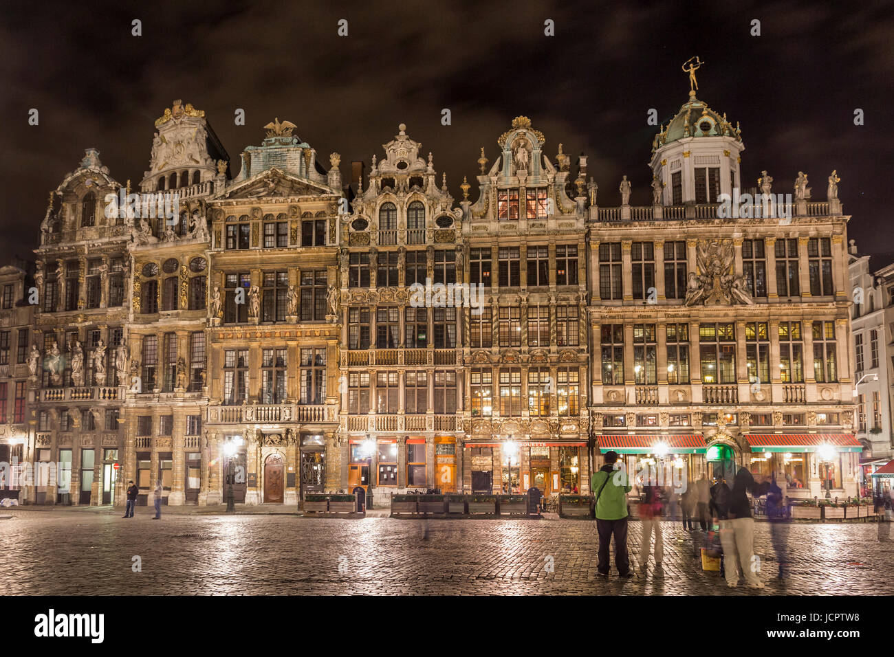 Facades of historic old buildings in famous Grand Place square at night ...