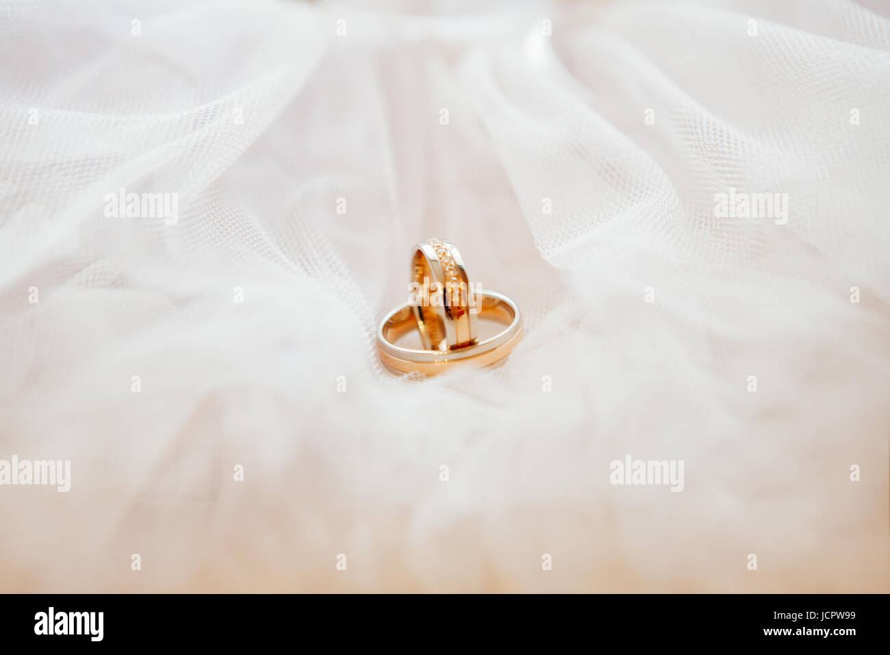 gold wedding rings on a white background Stock Photo - Alamy