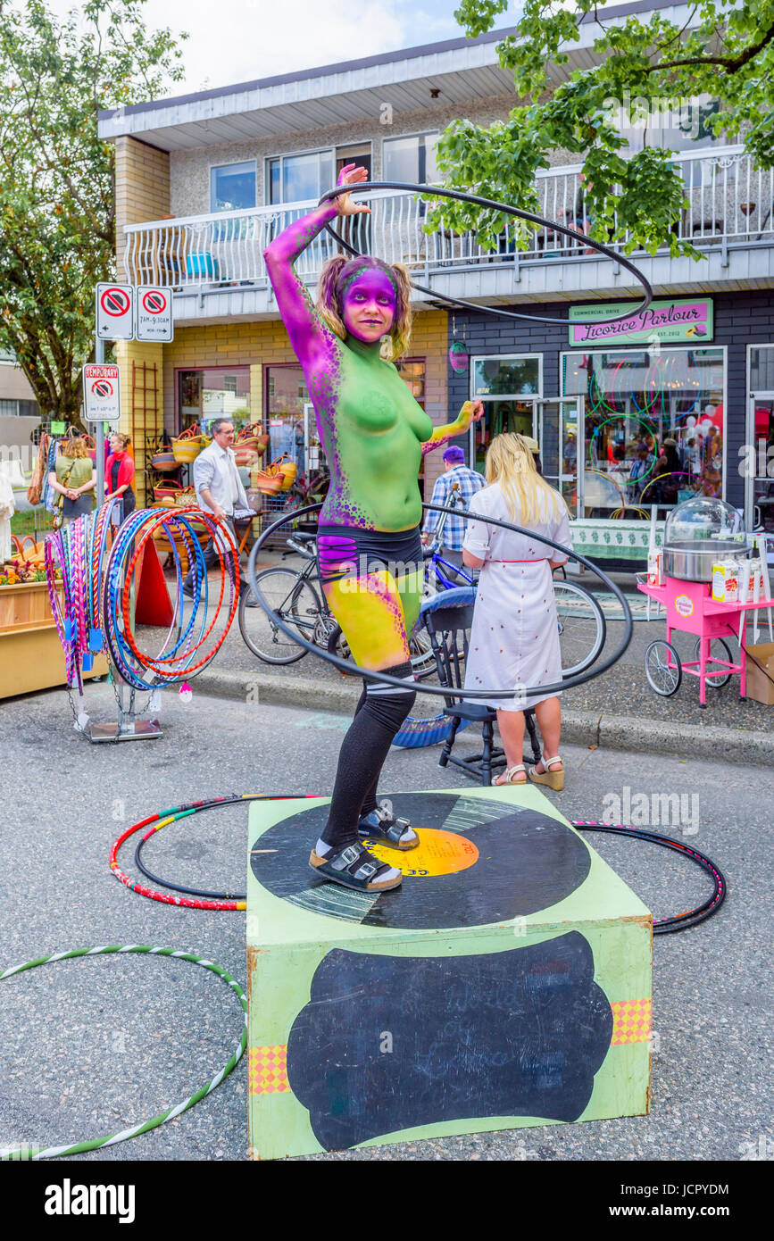 Bare breasted body painted woman perforing hula hoops, Italian Day ...
