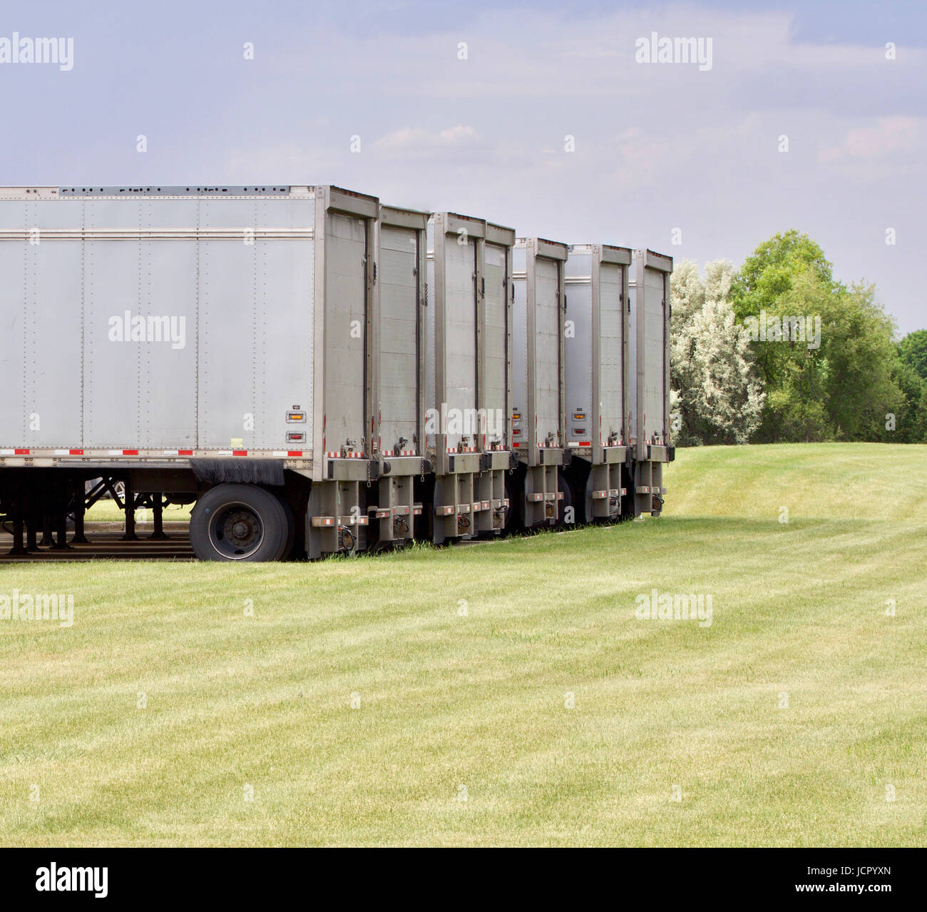 Semi trailers waiting to be loaded Stock Photo - Alamy