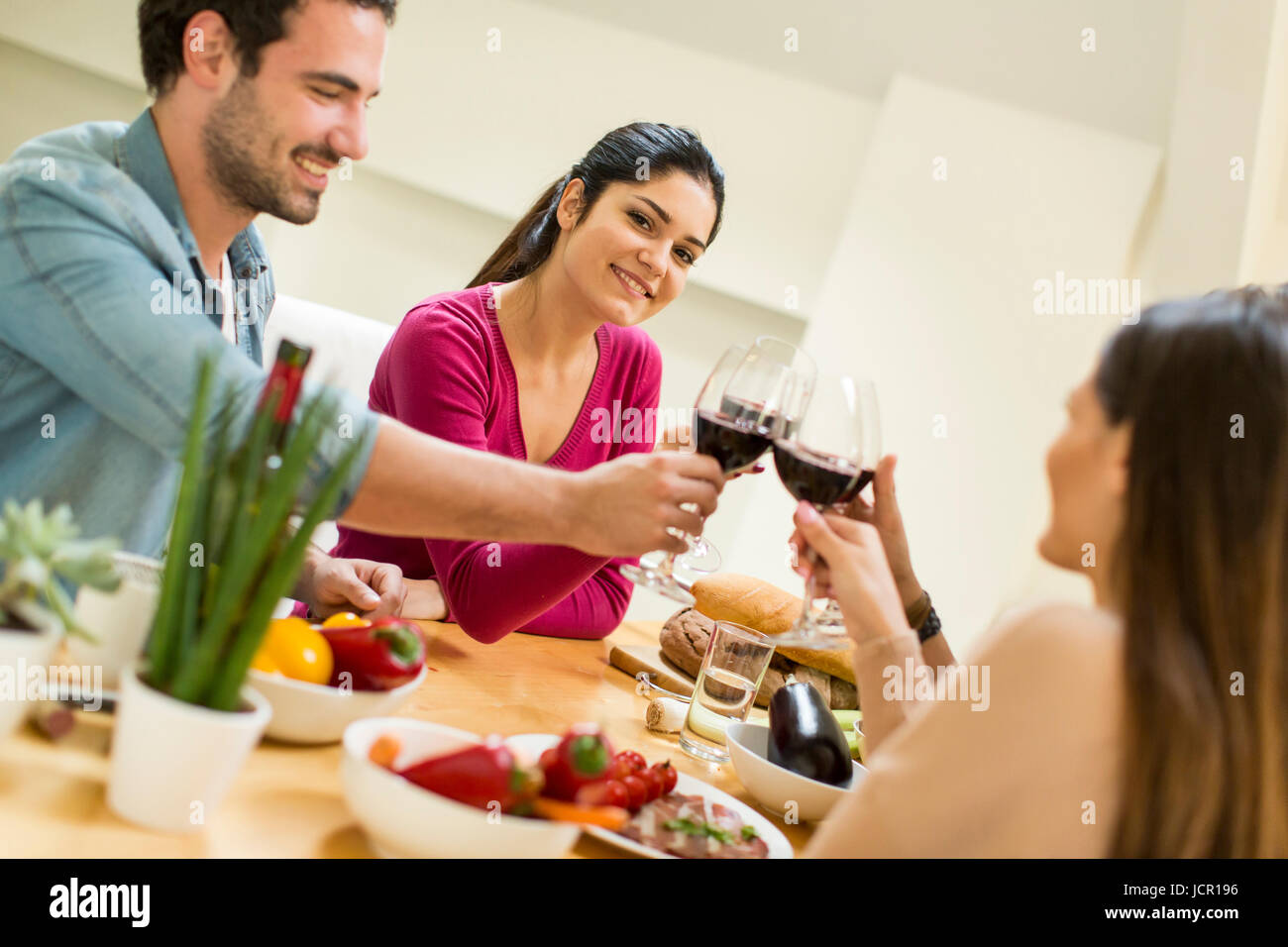 View at young people have a meal in the dining room in modern home ...