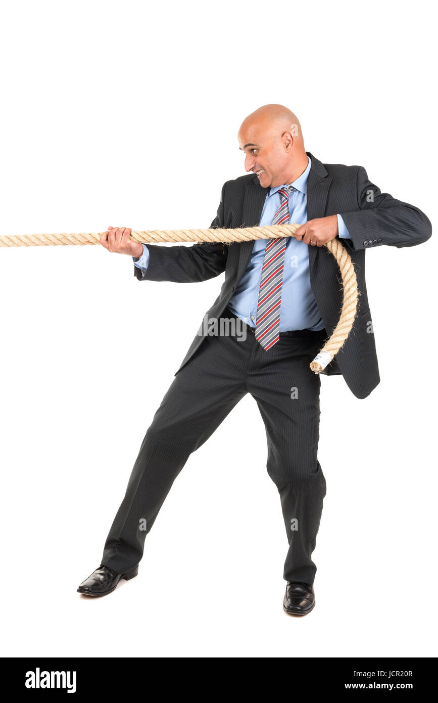 Businessman pulling a rope isolated in white Stock Photo - Alamy