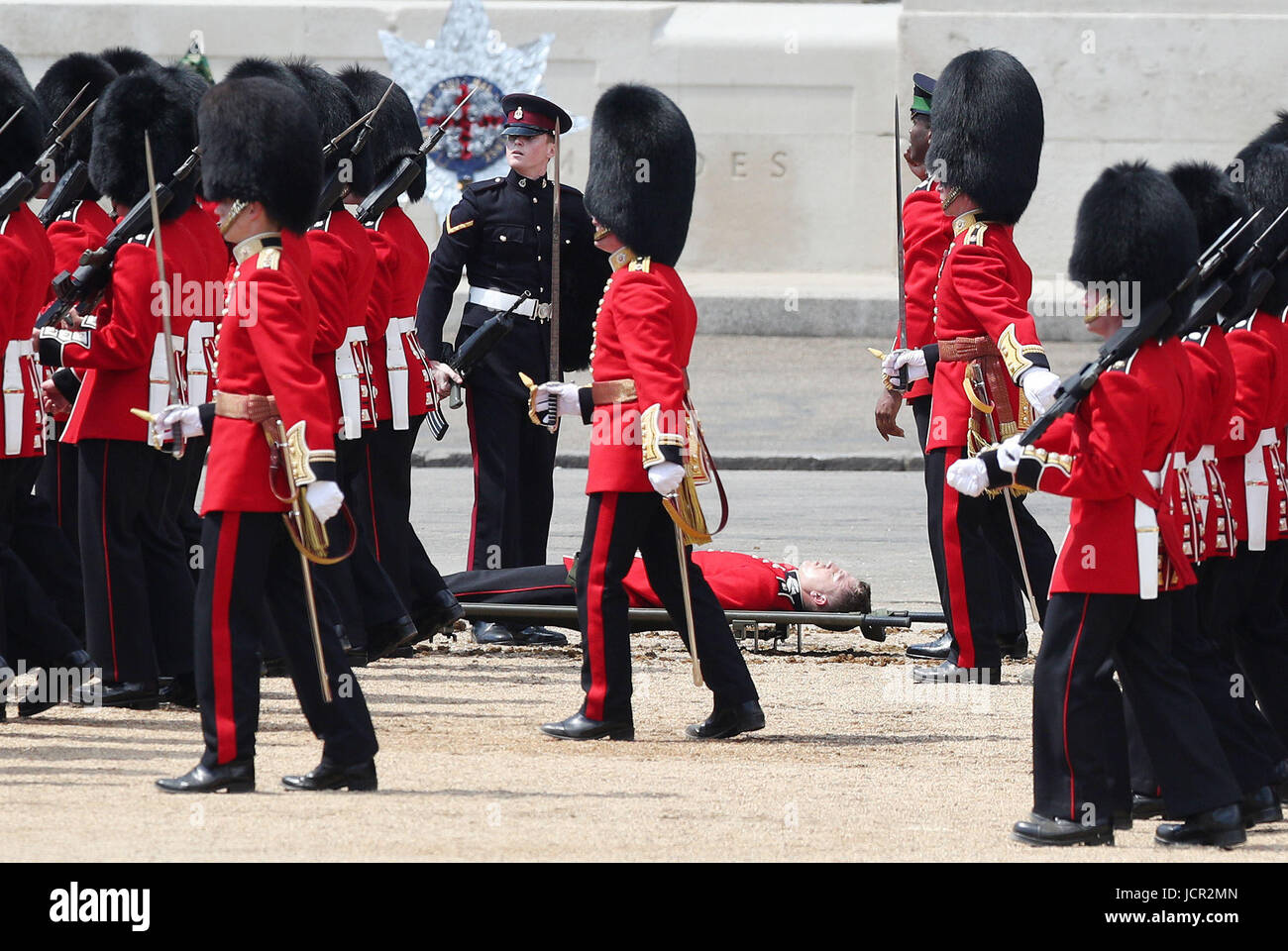 A Guardsman on a stretcher after fainting during the Trooping the ...