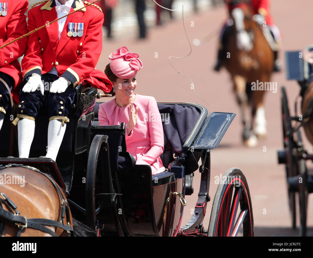 The Duchess of Cambridge waves as the Royal procession makes its way up ...