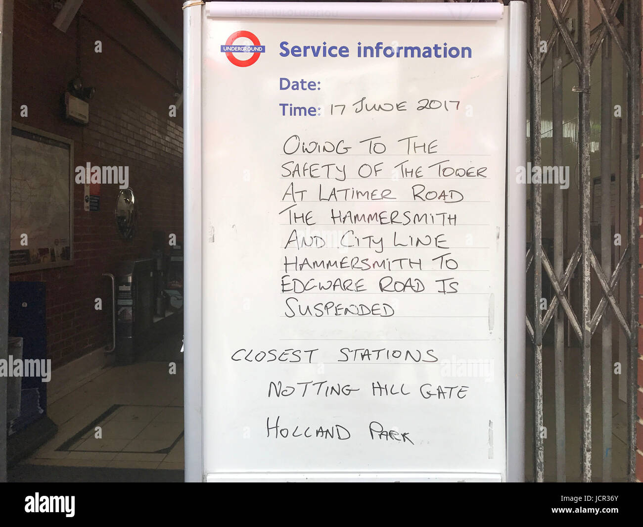 People look at a sign at Labroke Grove Station in London, which says ...