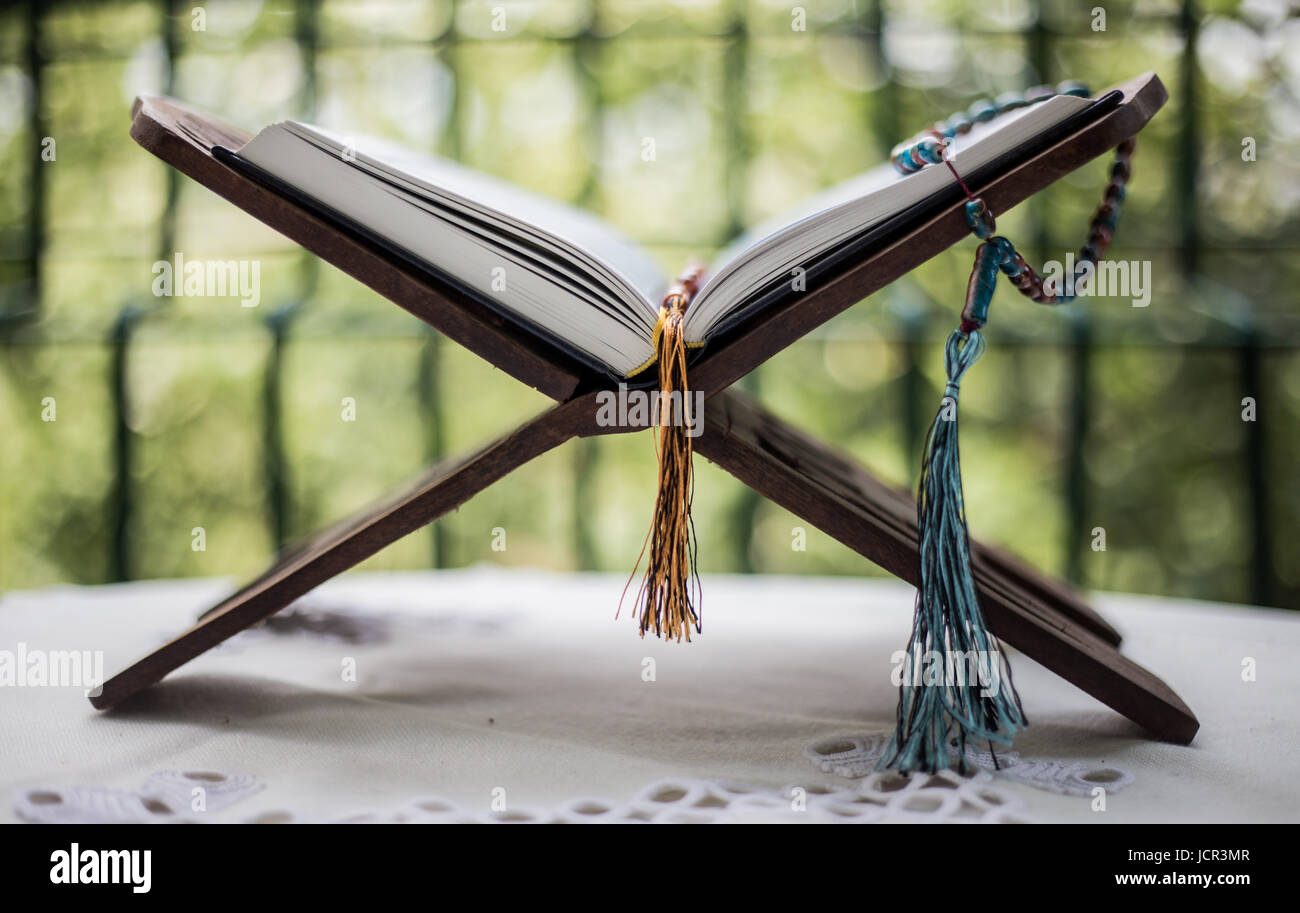 Open holy quran on wood stand hi-res stock photography and images - Alamy