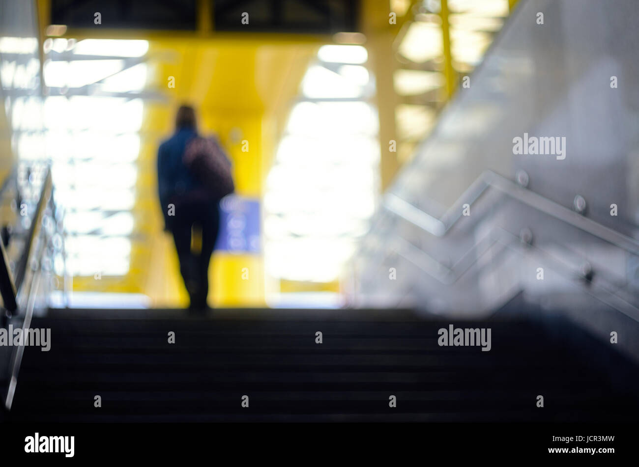 Figure of a person emerging from an underground passage. Blurred ...