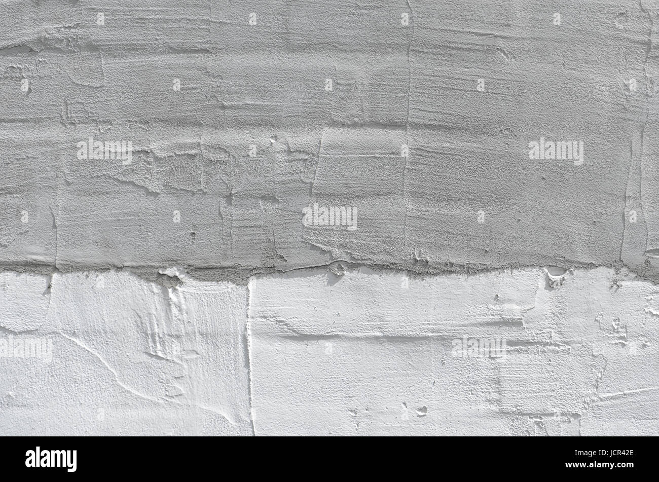 Thin layer of plaster on a brick wall. White and gray plaster wall ...