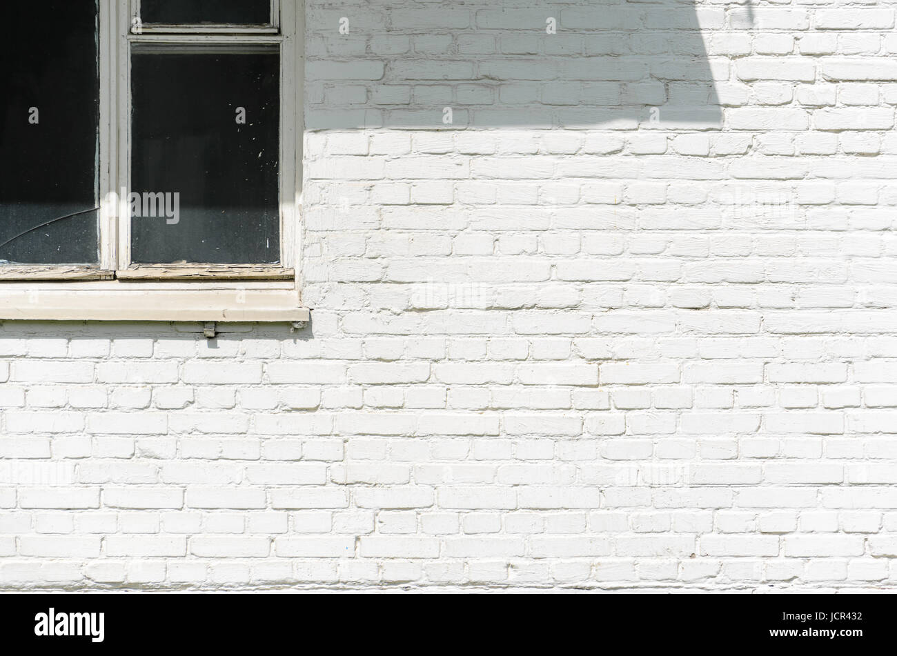A white brick wall facade with window Stock Photo - Alamy
