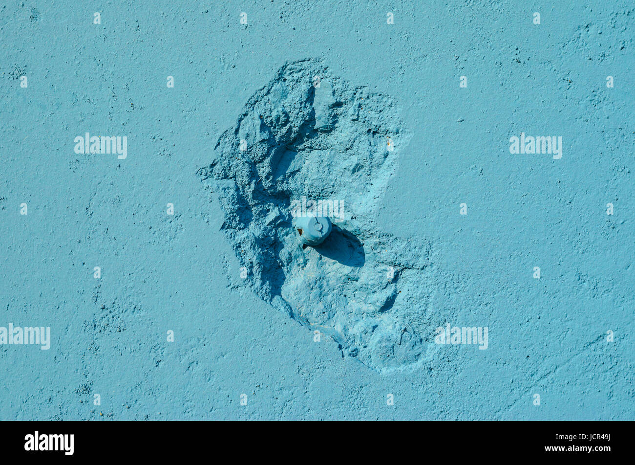 Blue plaster wall texture with protruding fittings. Empty plaster ...