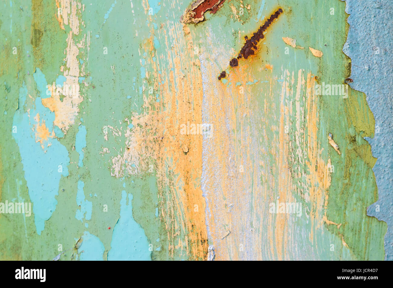 Yellow paint smears on a metal surface. Old metal texture for ...