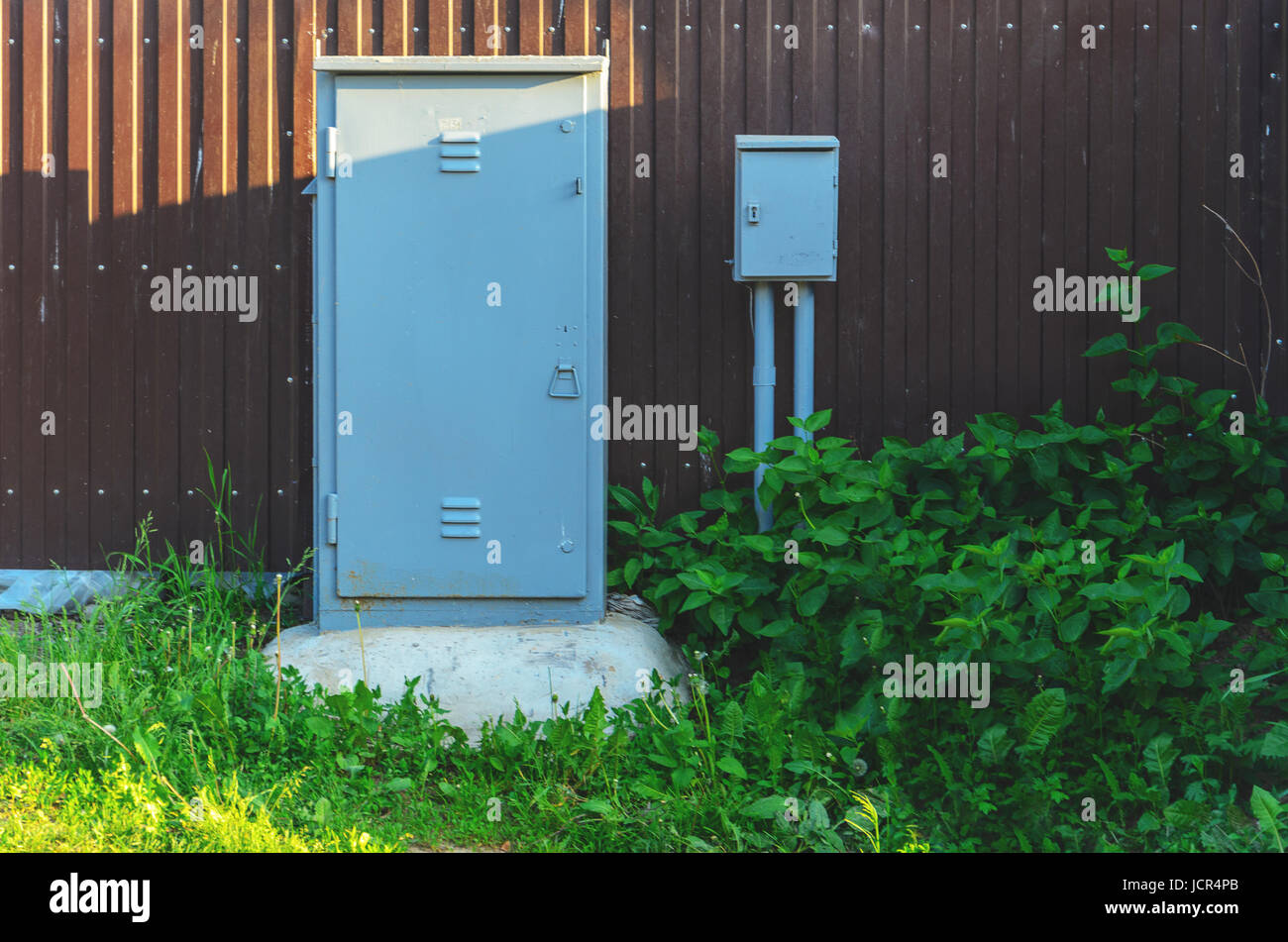 Outdoor electrical panel against the background of the metal facade ...
