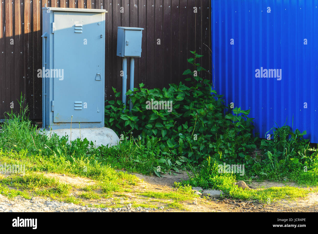 Outdoor electrical panel against the background of the metal facade ...