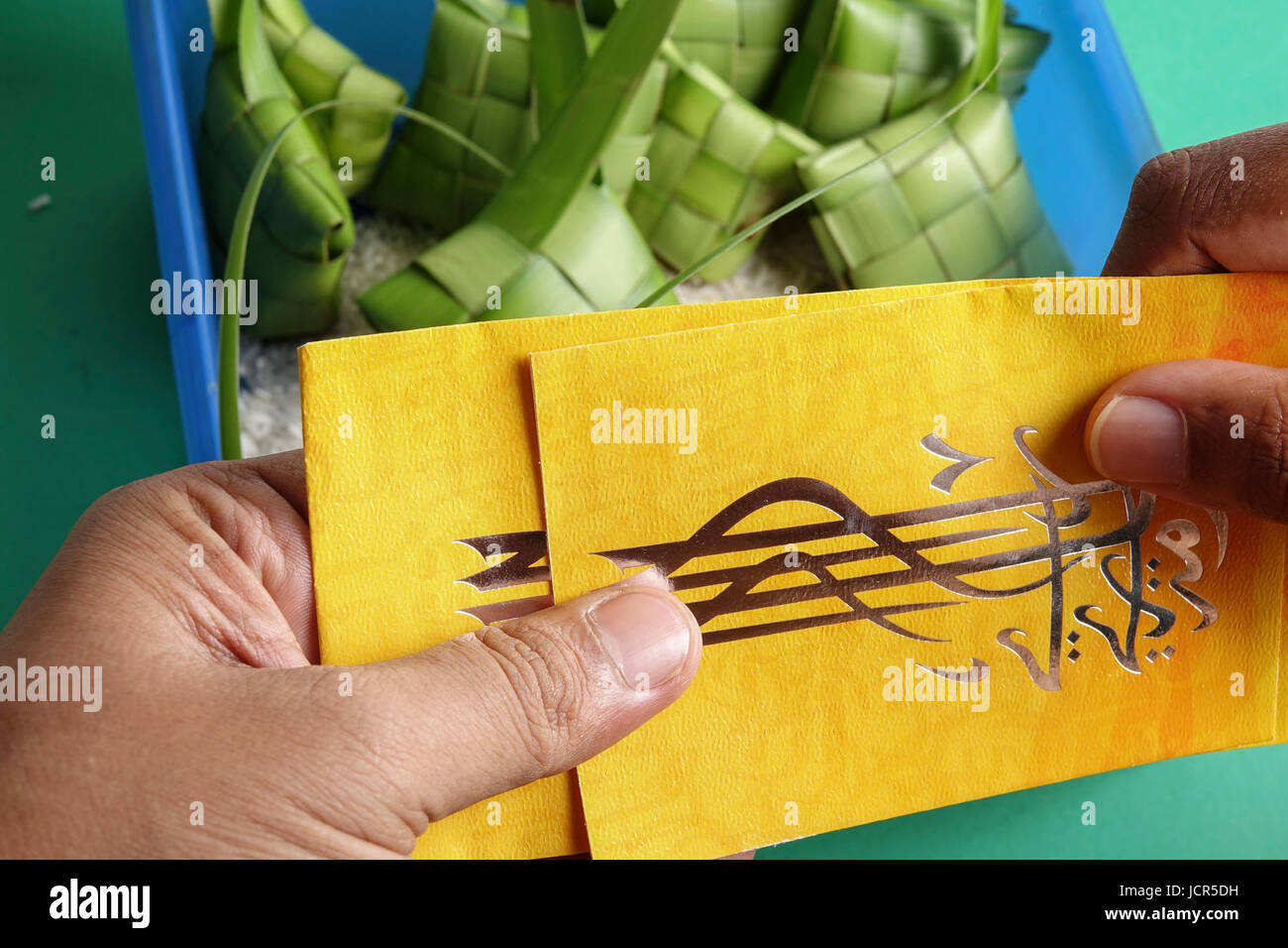 Giving And Receiving Money Packet During Eid Fitri Arabic Character Means Eid Mubarak Stock giving-and-receiving-money-packet-during-eid-fitri-arabic-character-means-eid-mubarak-stock