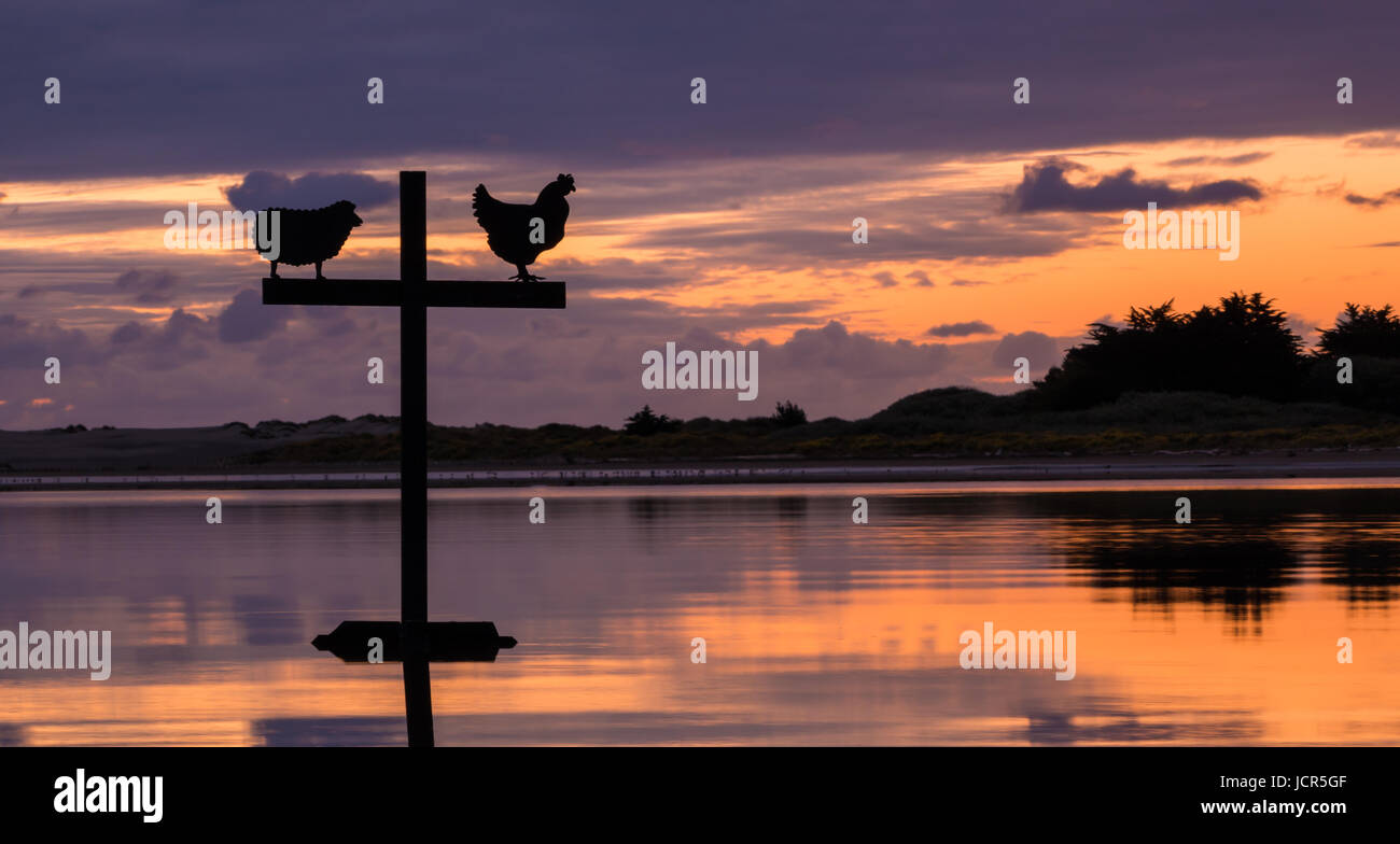 Black cross with an sheep and a rooster on it Stock Photo - Alamy