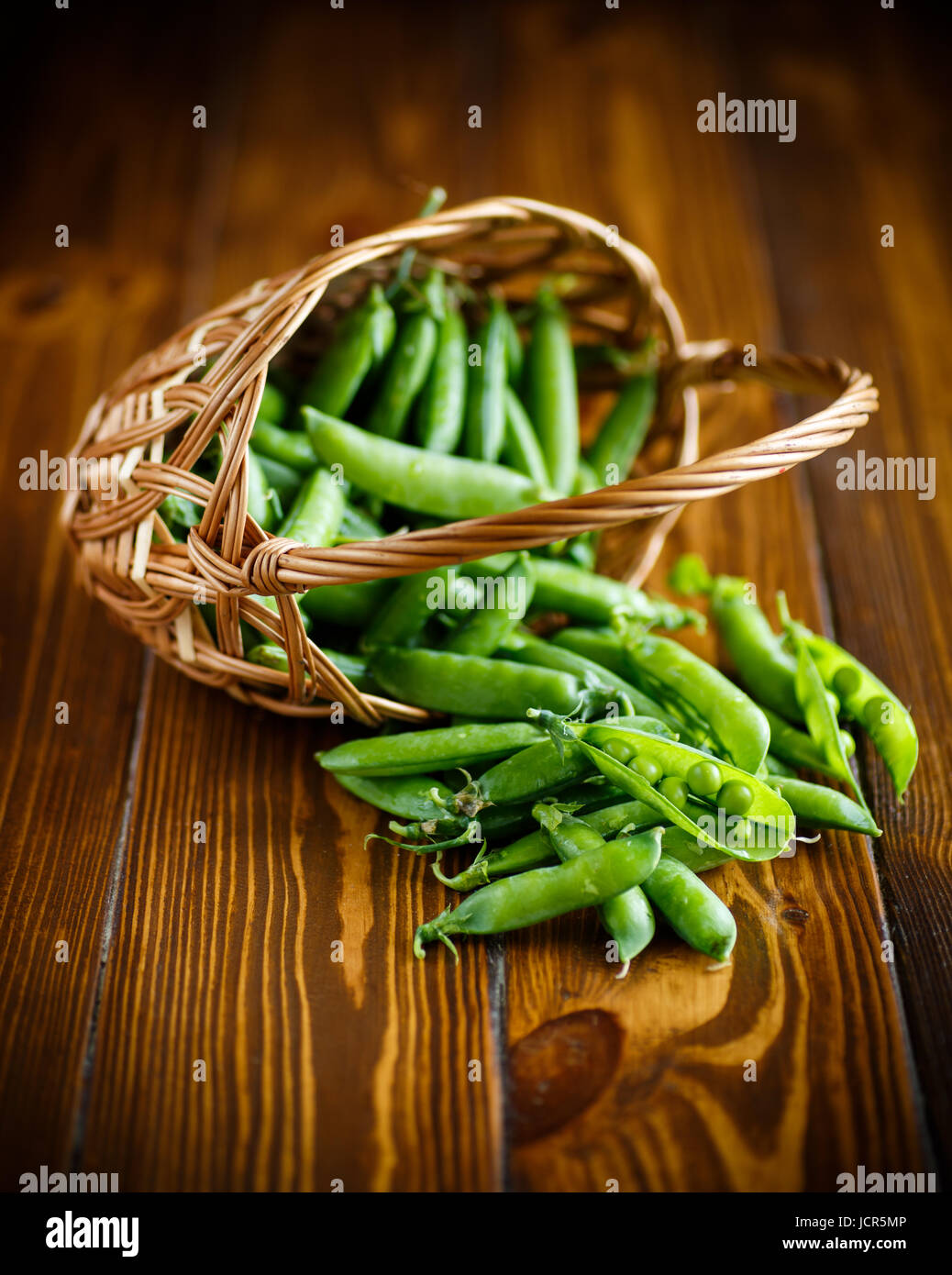 Fresh early green peas in a basket Stock Photo - Alamy