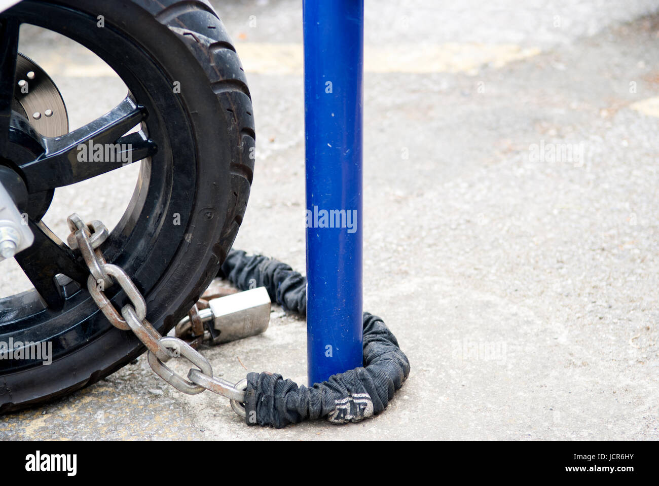 motorcycle locked with a chain to prevent theft Stock Photo - Alamy