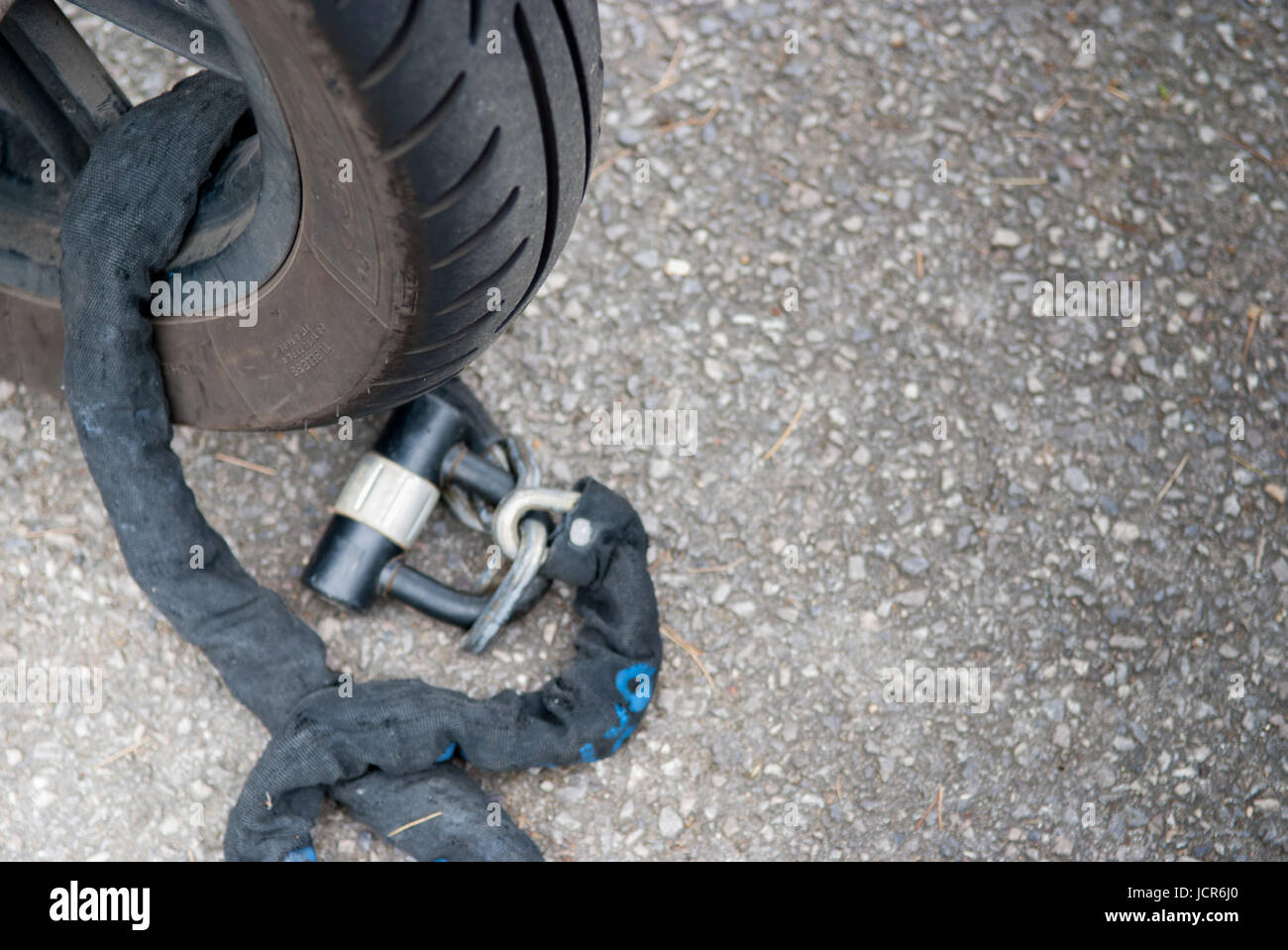 motorcycle locked with a chain to prevent theft Stock Photo - Alamy