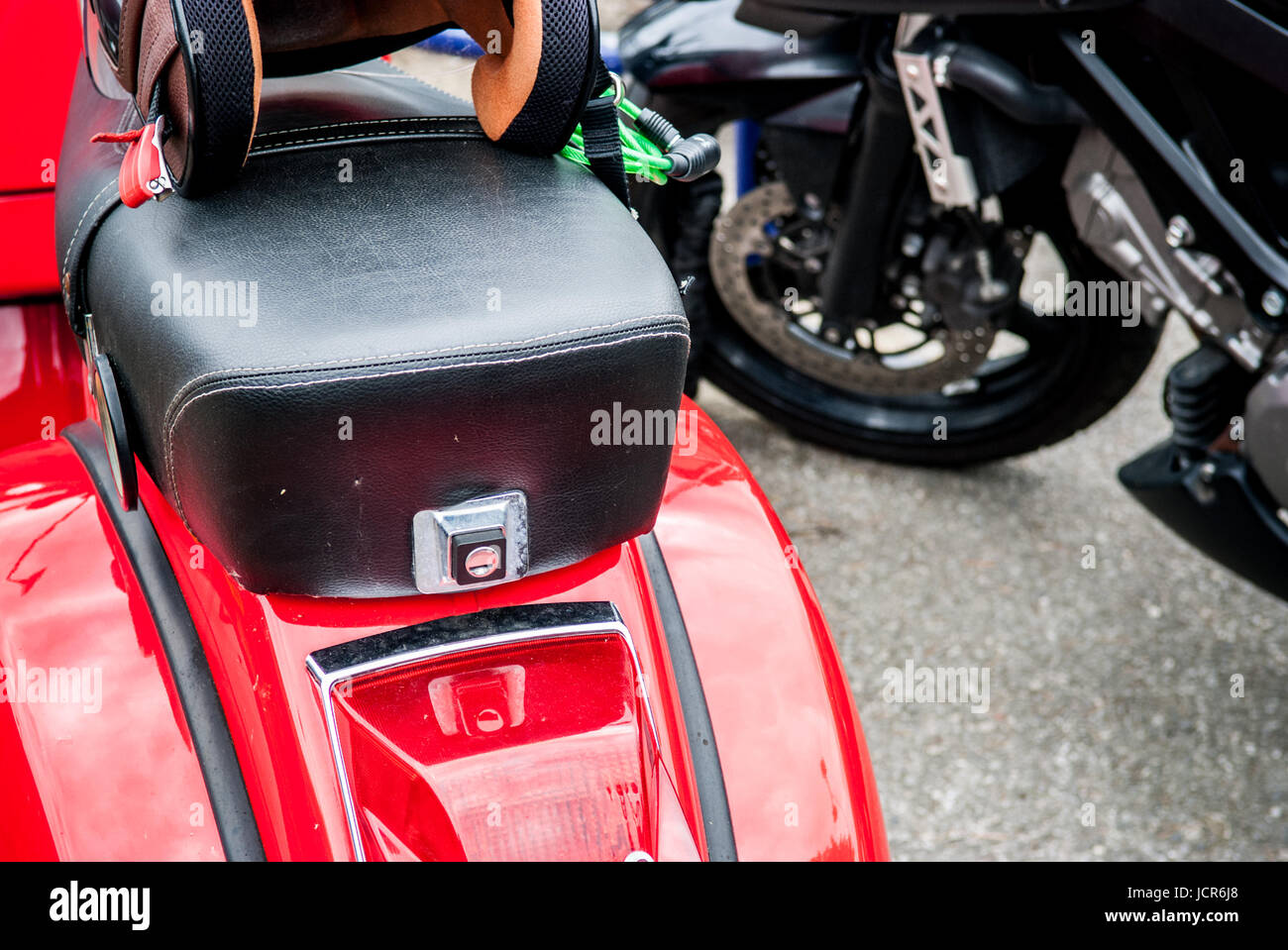 Retro style red motor scooter with crash helmet Stock Photo - Alamy