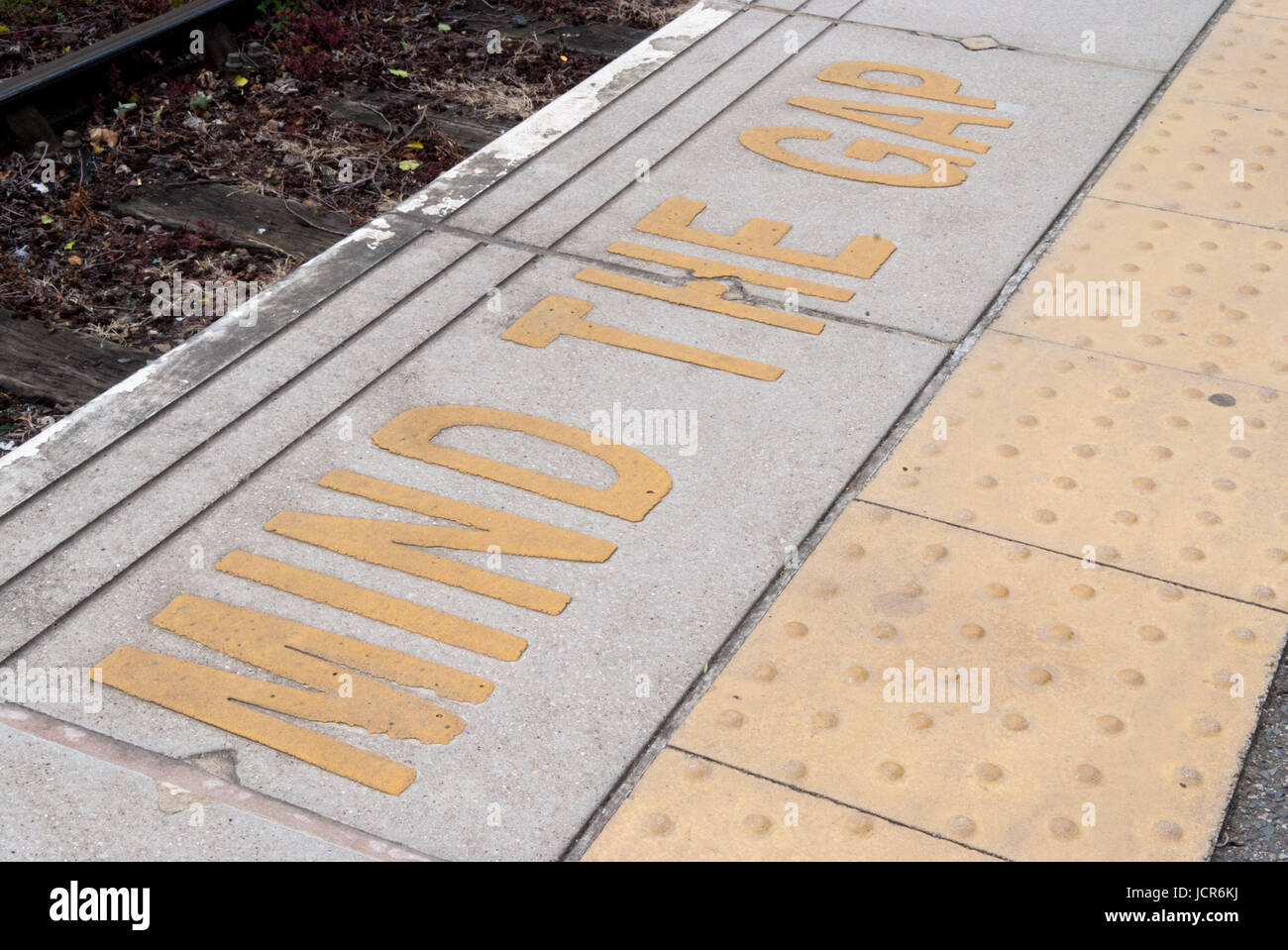 Platform edge at the train station with safety warning Stock Photo - Alamy