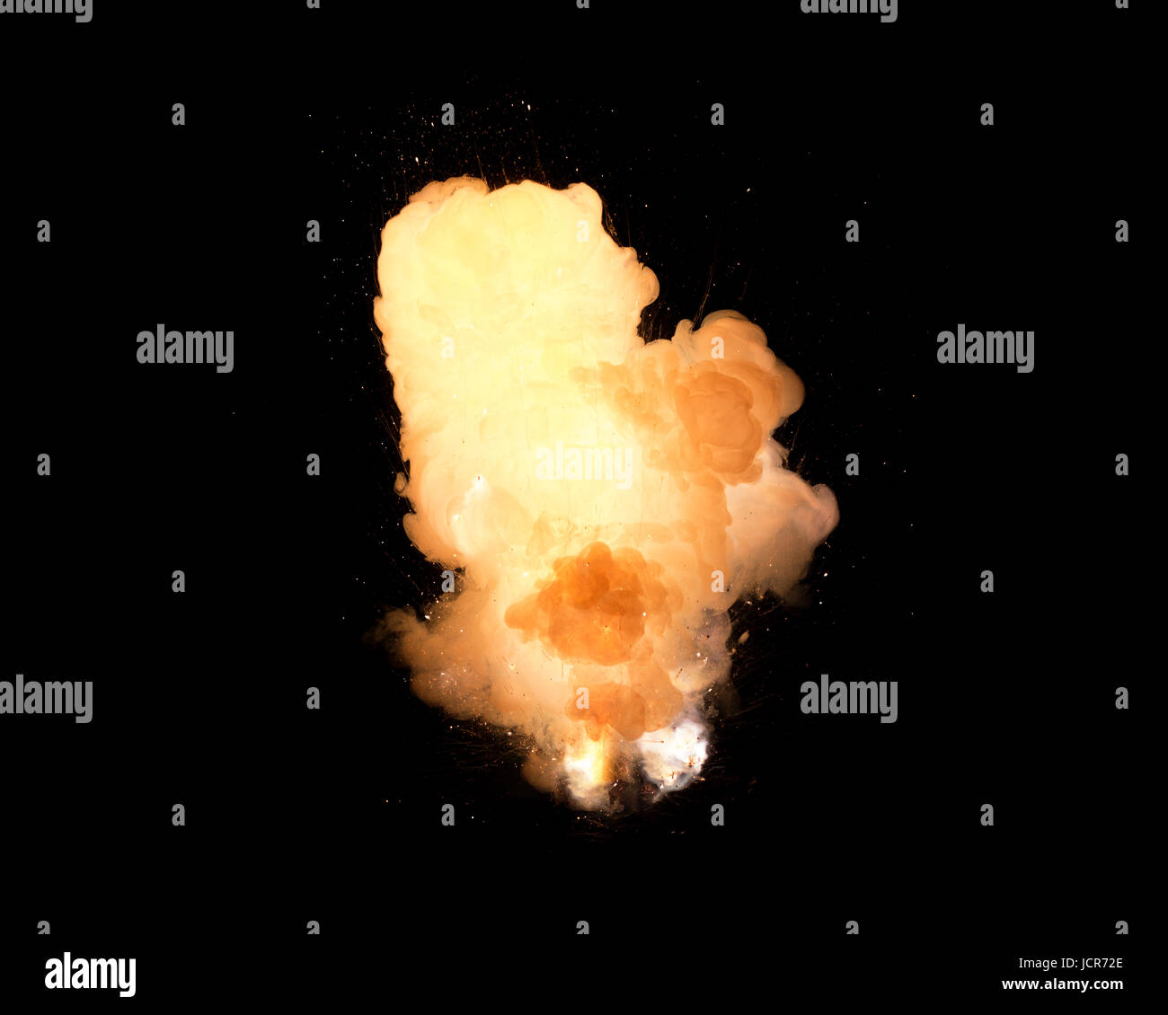 Huge, extremely hot explosion with sparks and hot smoke, against black ...