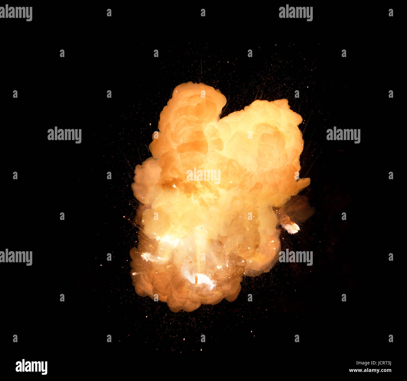 Huge, extremely hot explosion with sparks and hot smoke, against black ...