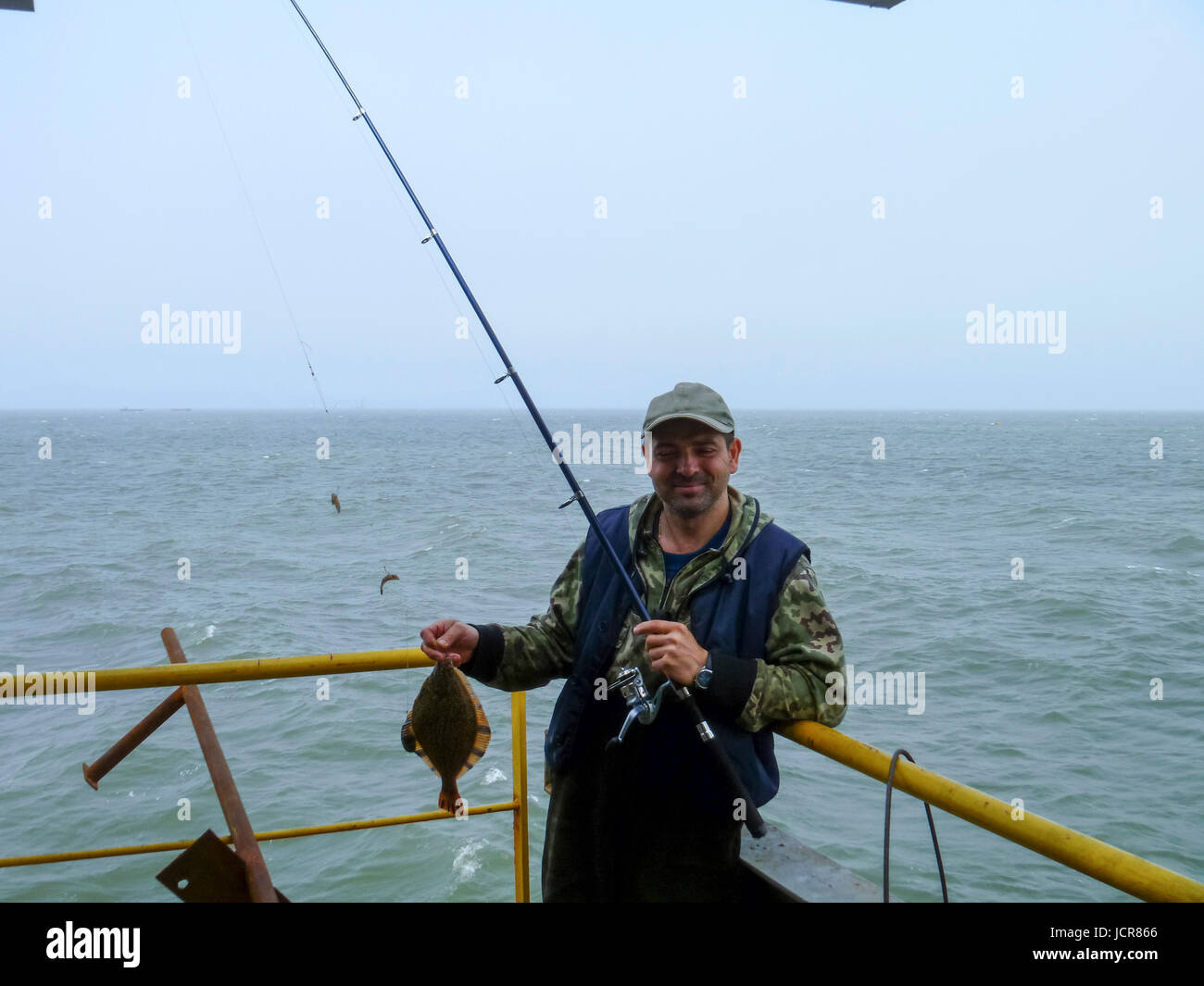 Flounder on the deck. Fishing on the boat. Bottom fish Stock Photo - Alamy