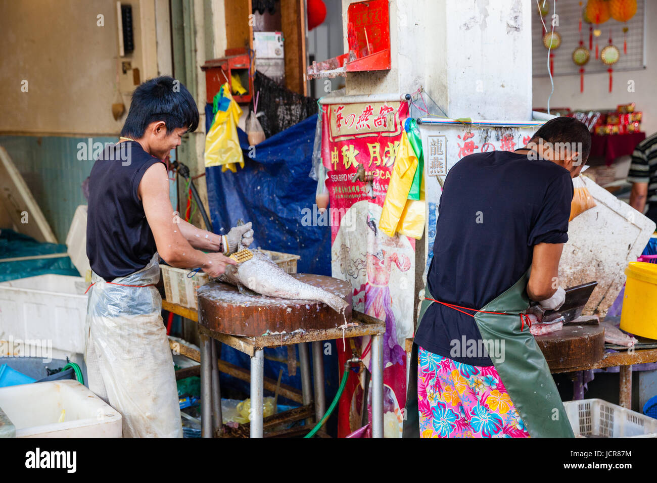 GEORGE TOWN, MALAYSIA - MARCH 23: Fishmonger cleans fresh fish for ...