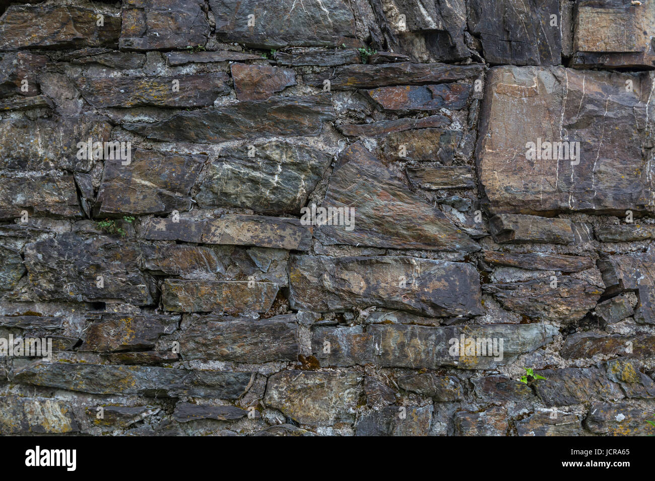 Stone wall made of old stone structure Stock Photo - Alamy