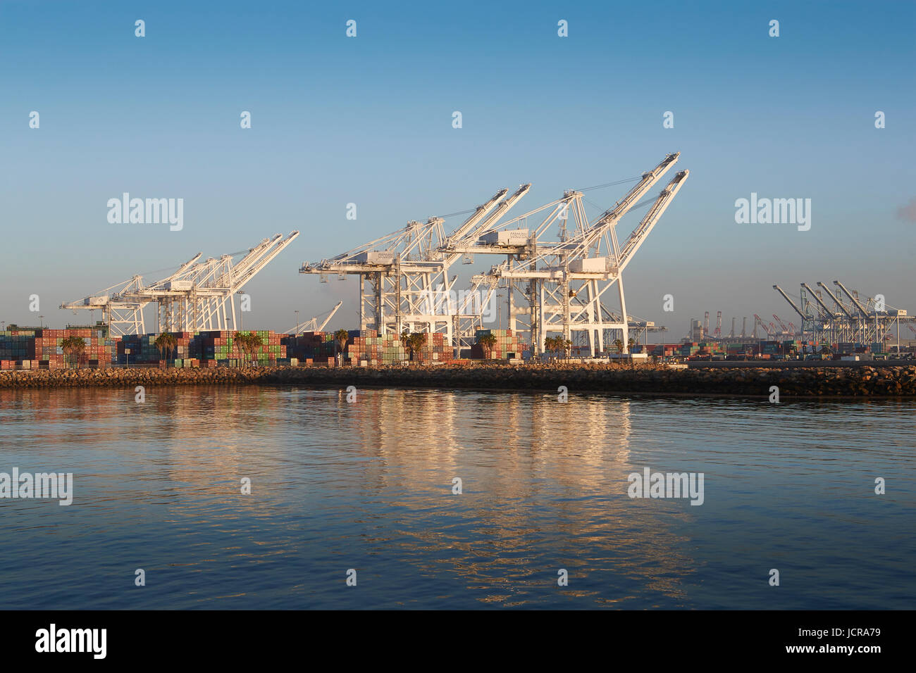 Raised Gantry Cranes And Stacked Shipping Containers In The Long Beach ...