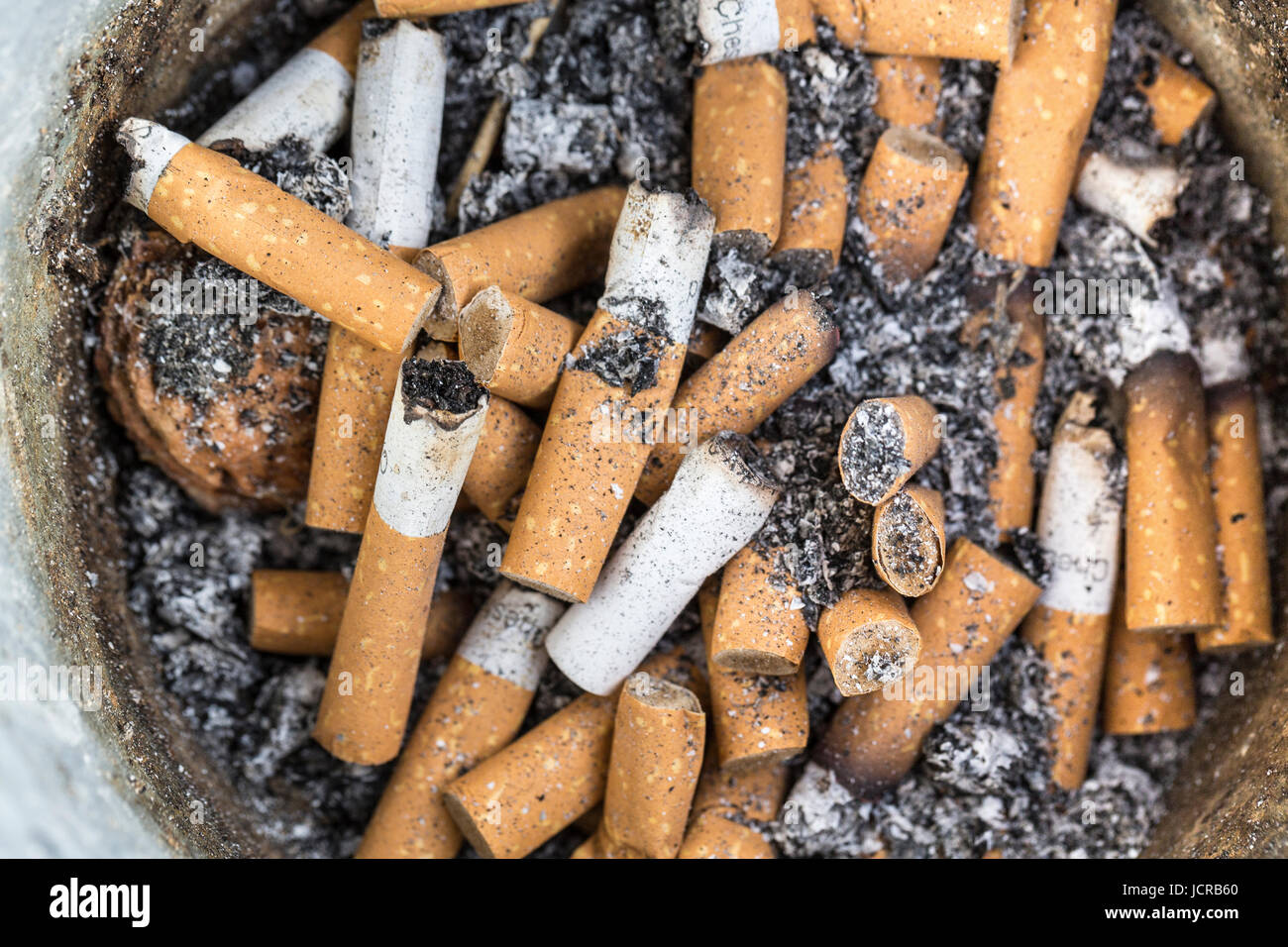 The used cigarettes stub placed on big jar Stock Photo - Alamy