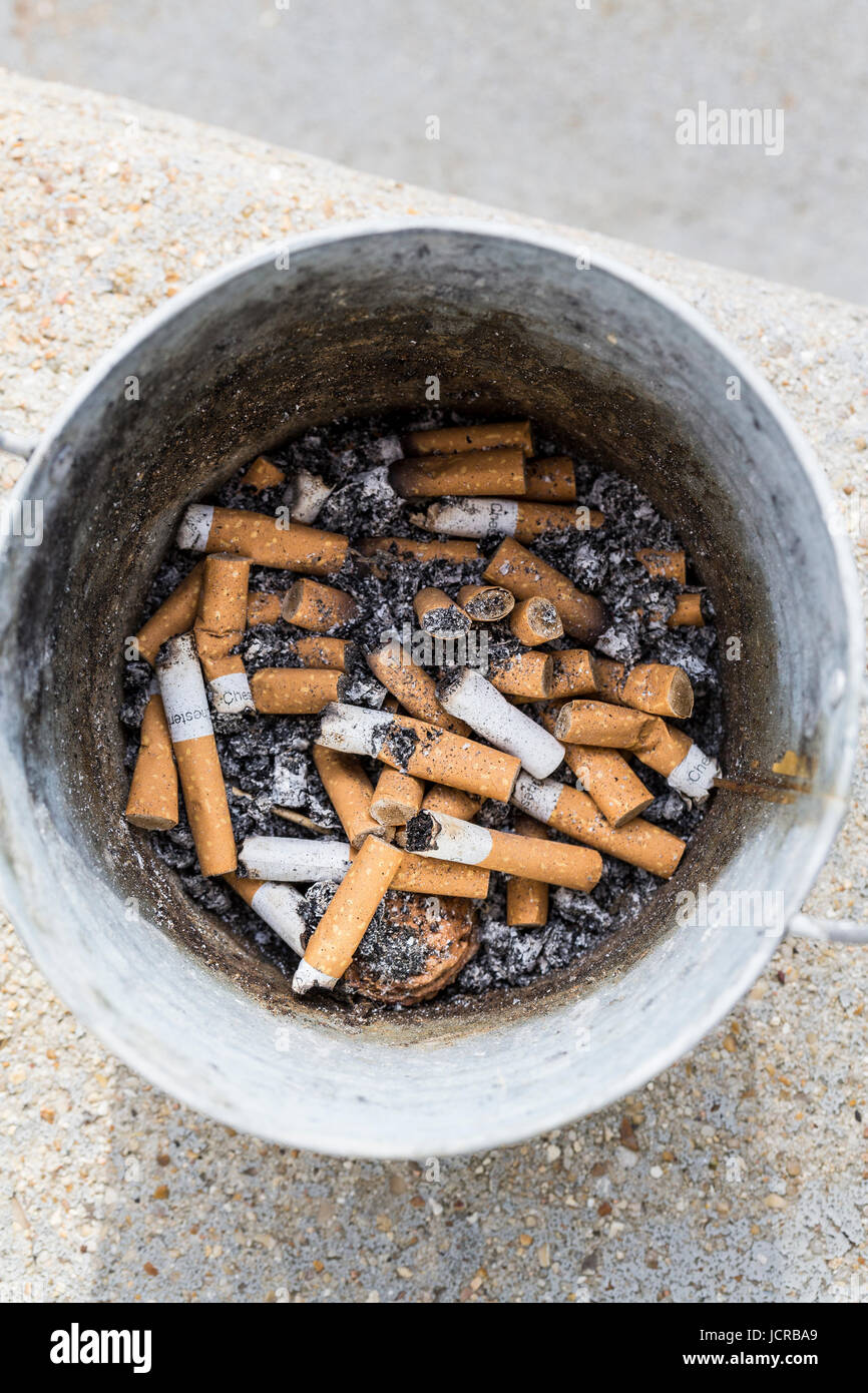 The used cigarettes stub placed on big jar Stock Photo - Alamy