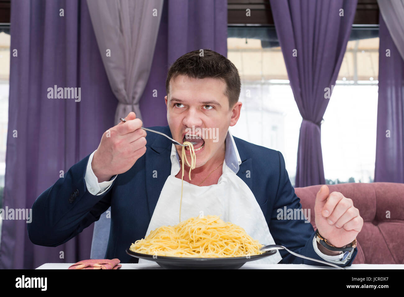 Man eating a large portion of pasta in a restaurant Stock Photo - Alamy
