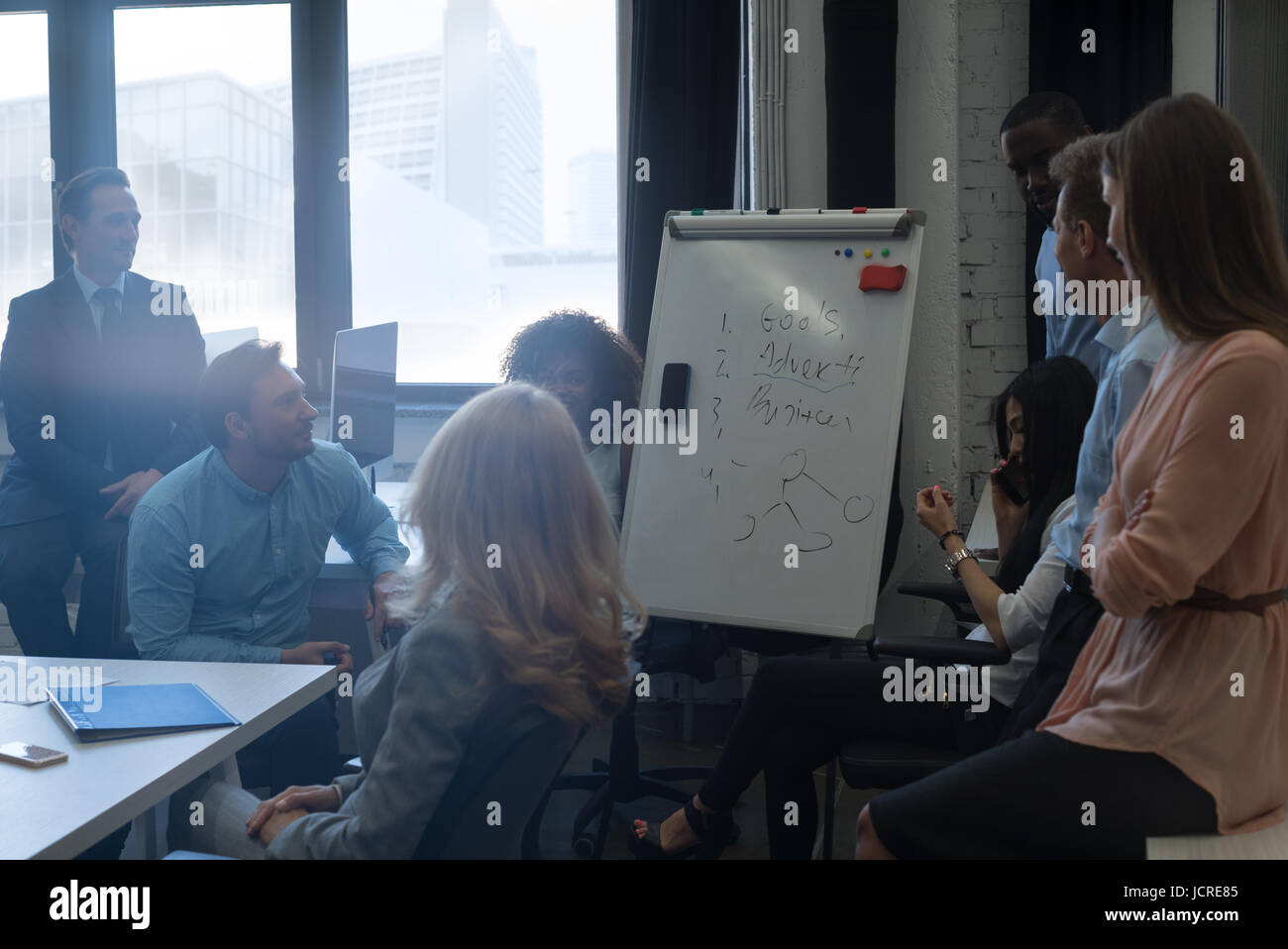 Mix Race Businesspeople Having Presentation On Flip Chart While Meeting ...
