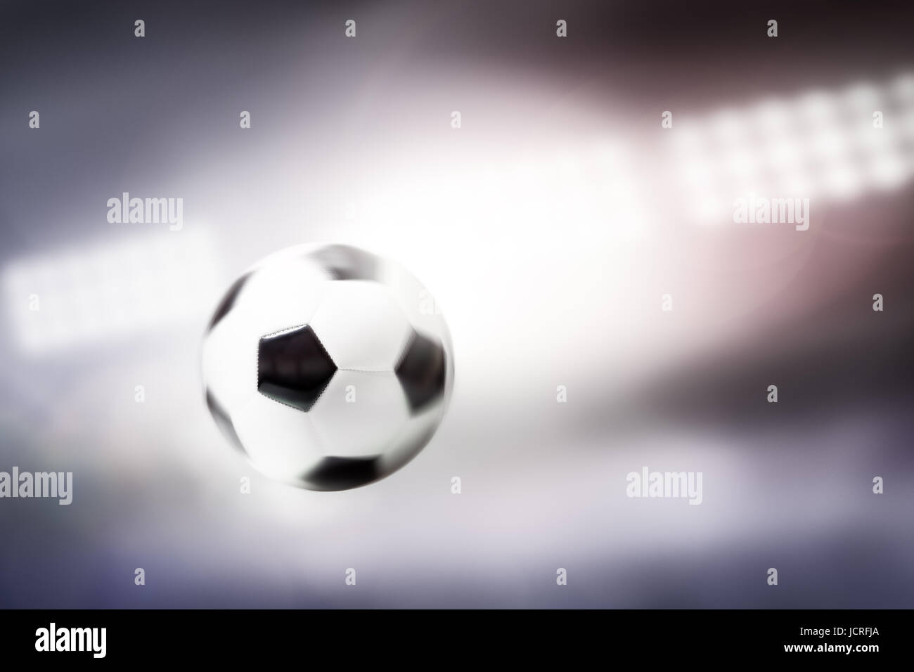background image of football flying through the air against the lights ...