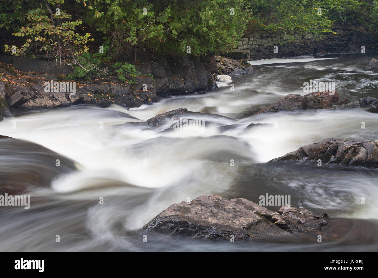 Waterfall and current movement in a river in the woods Stock Photo - Alamy