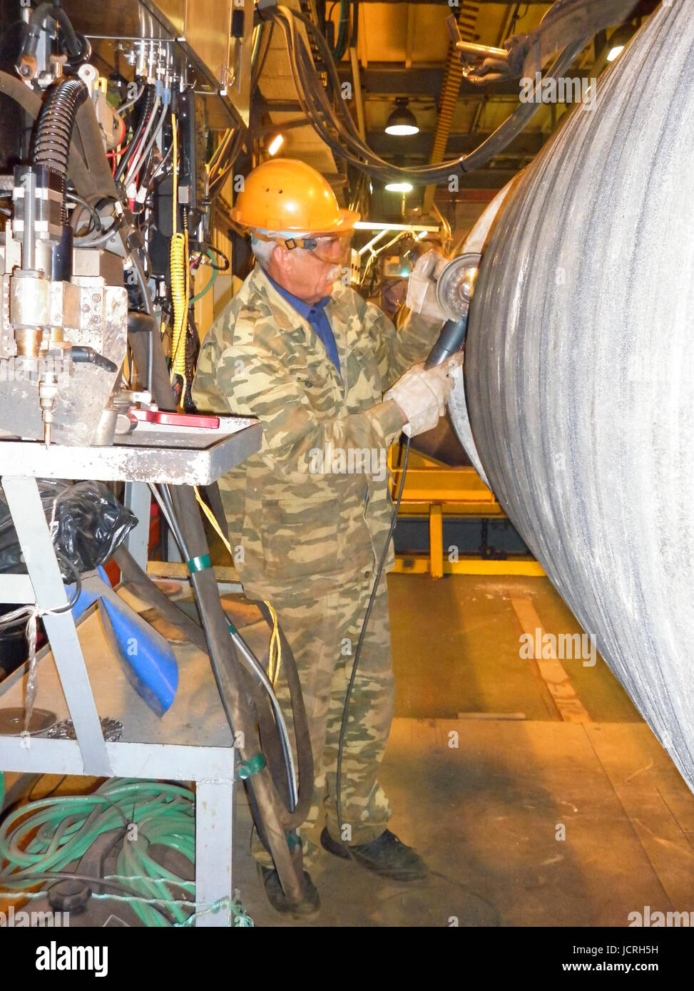 Weld preparation before installation. Workers clean the place of ...