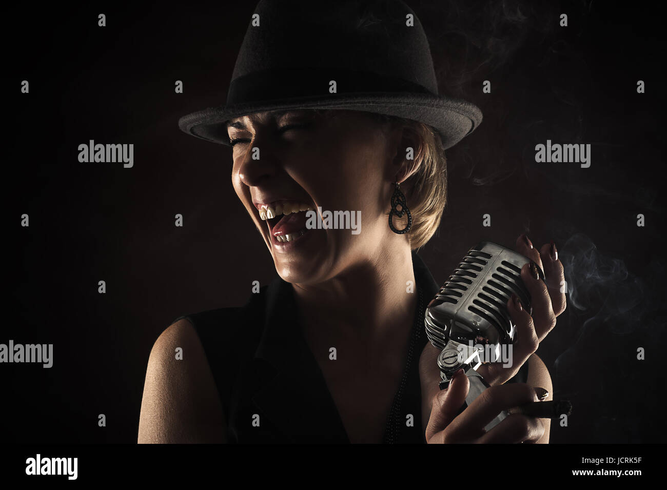 smiling jazz singer with retro microphone Stock Photo - Alamy