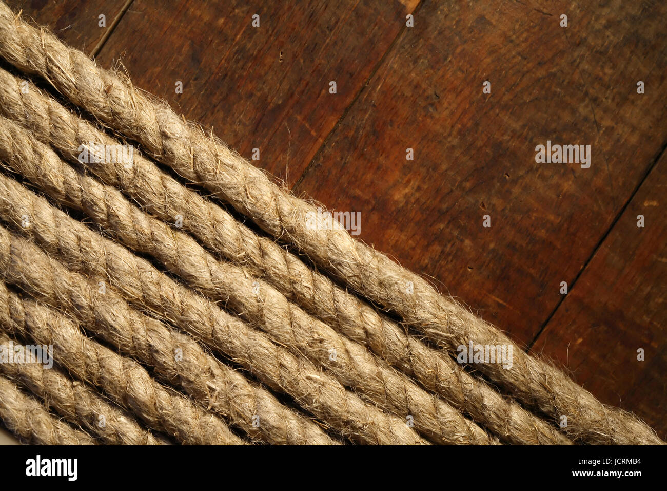 Old hemp rope on dark wooden surface Stock Photo - Alamy