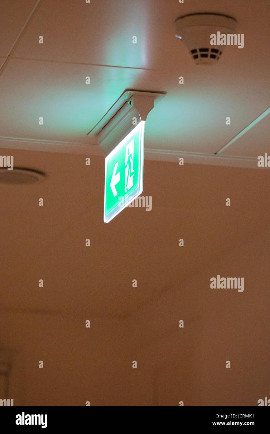 Illuminated fire exit sign Stock Photo - Alamy
