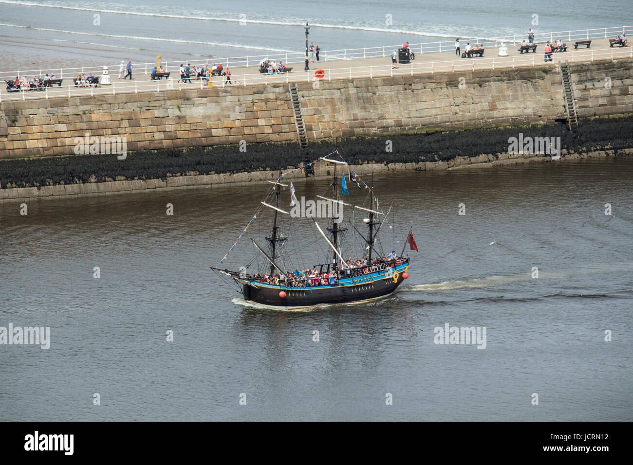 The sailing boat Bark Endeavour exiting Whitby Harbour at Whitby, North ...