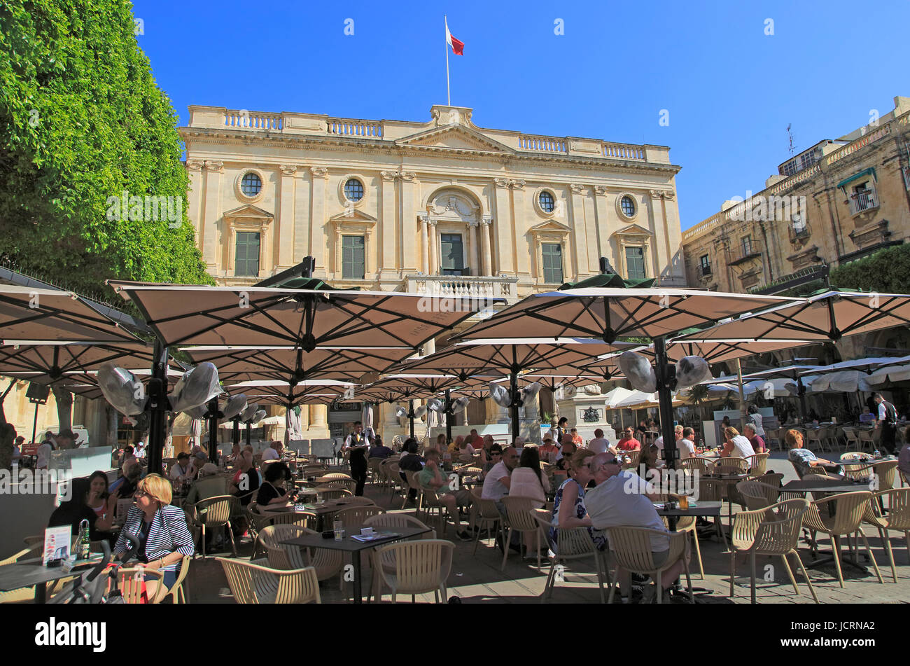 People at cafe tables in front of National Library building, Republic ...